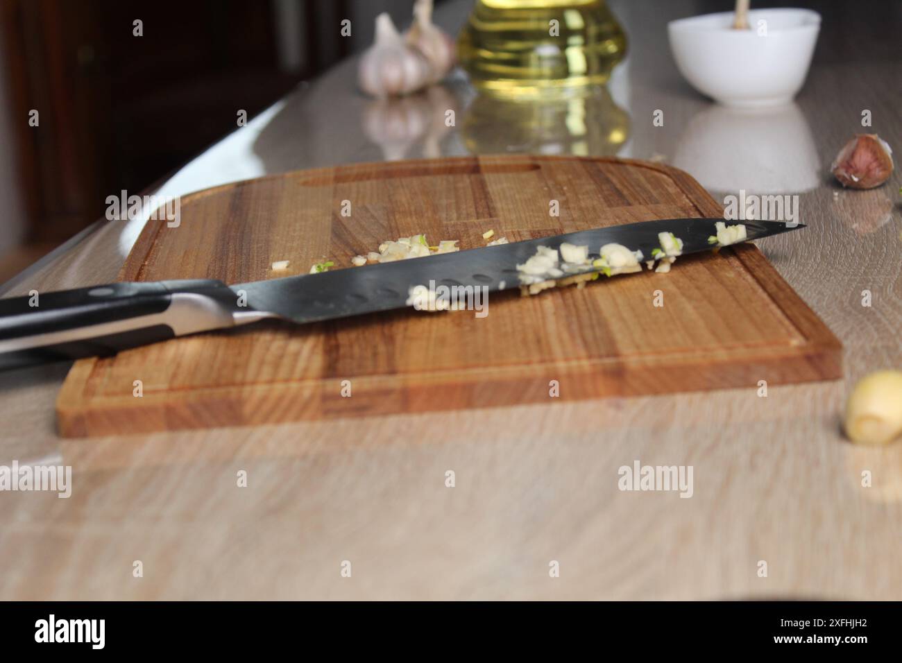 Cook cutting garlic on board. cooking in the kitchen slicing chopping ...