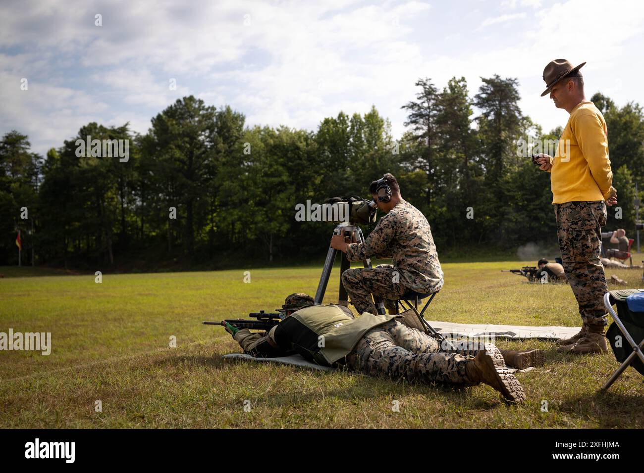 U.S. Marines with the United States Marine Corps Shooting Team assist ...