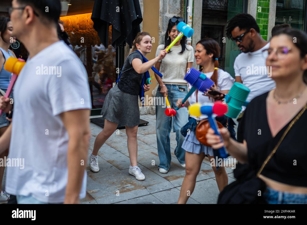 Greeting people with wilting leek and plastic hammers during Festival ...