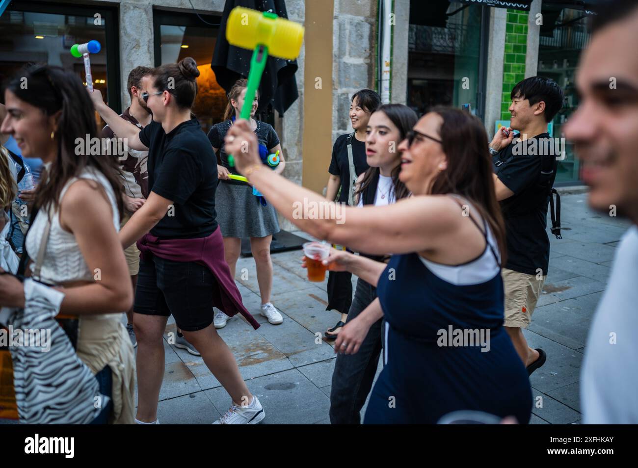 Greeting people with wilting leek and plastic hammers during Festival ...