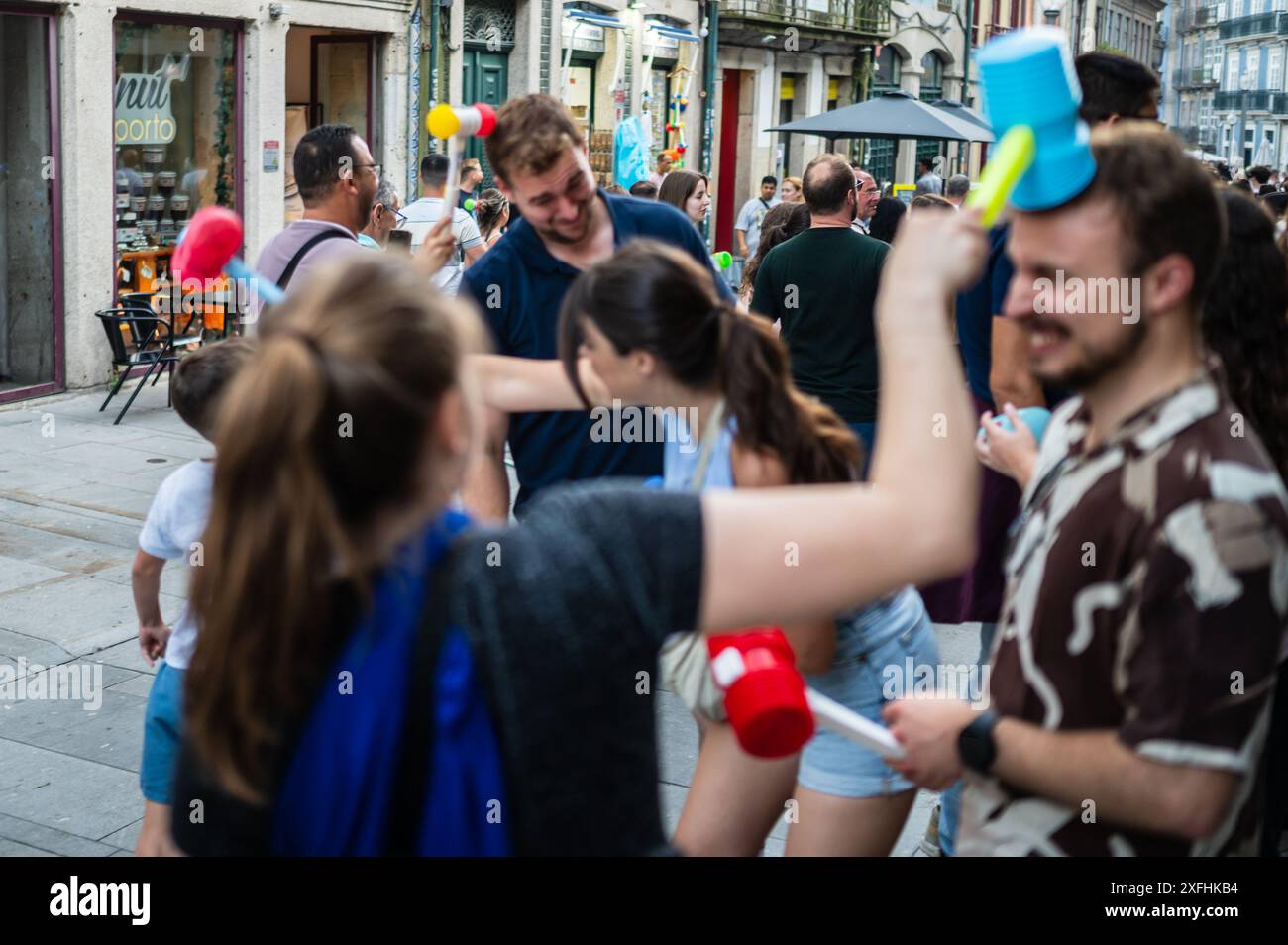 Greeting people with wilting leek and plastic hammers during Festival ...