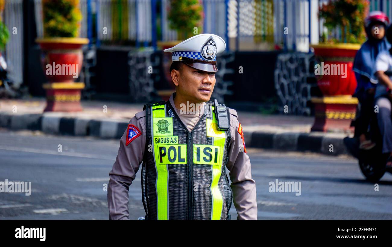 Indonesian police are controlling traffic on the road Stock Photo - Alamy