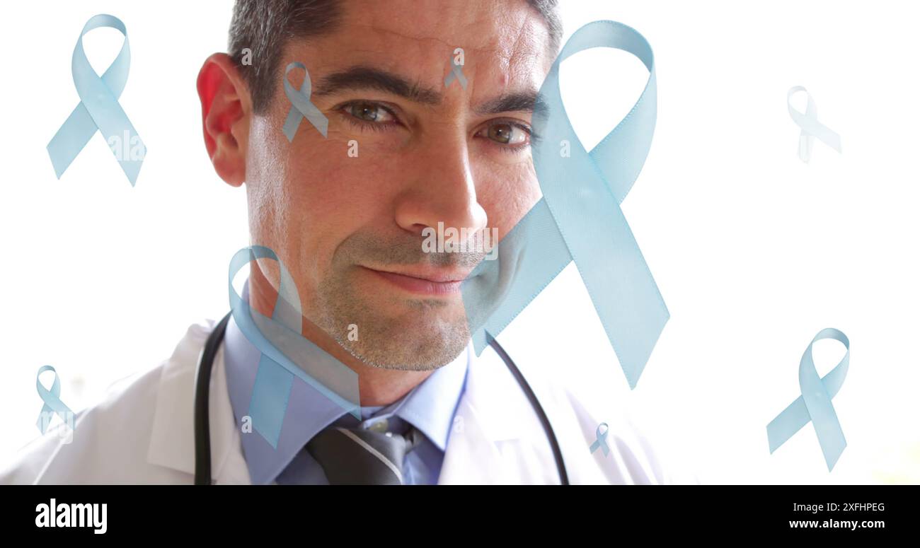 Image of blue cancer ribbons over smiling caucasian male doctor on ...