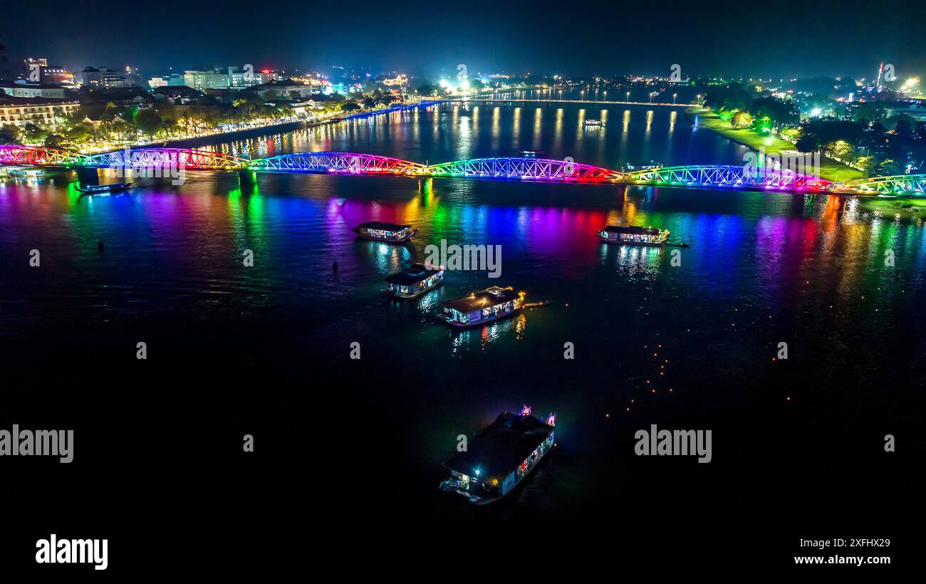 Aerial view of Hue City, Vietnam at night. Bridge illuminated all over ...