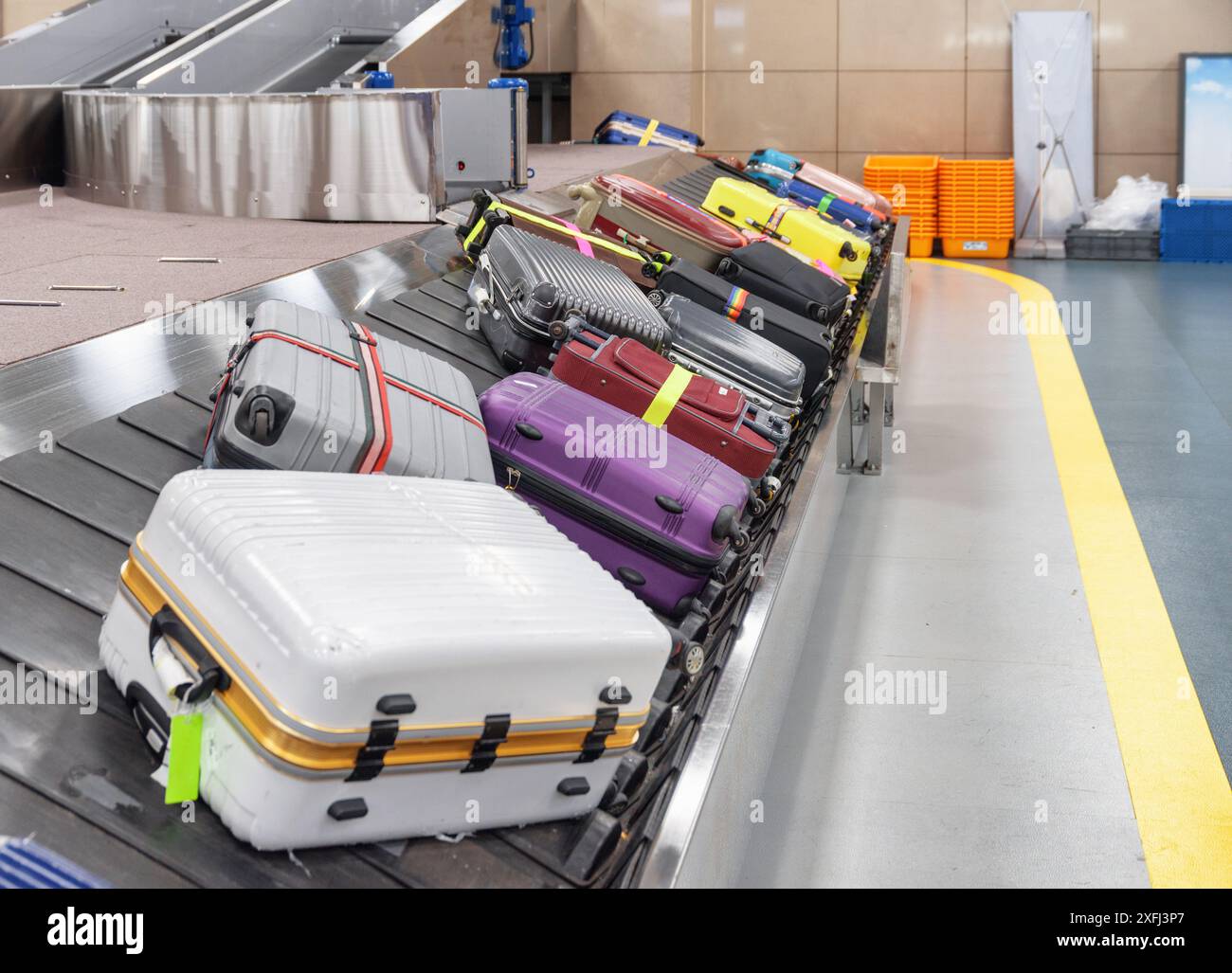 Colorful suitcases on luggage conveyor belt at arrival area of ...