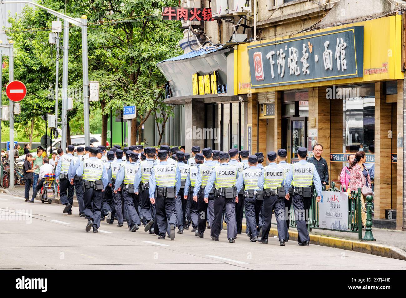 Shanghai, China - October 3, 2017: Policemen walking along street at ...