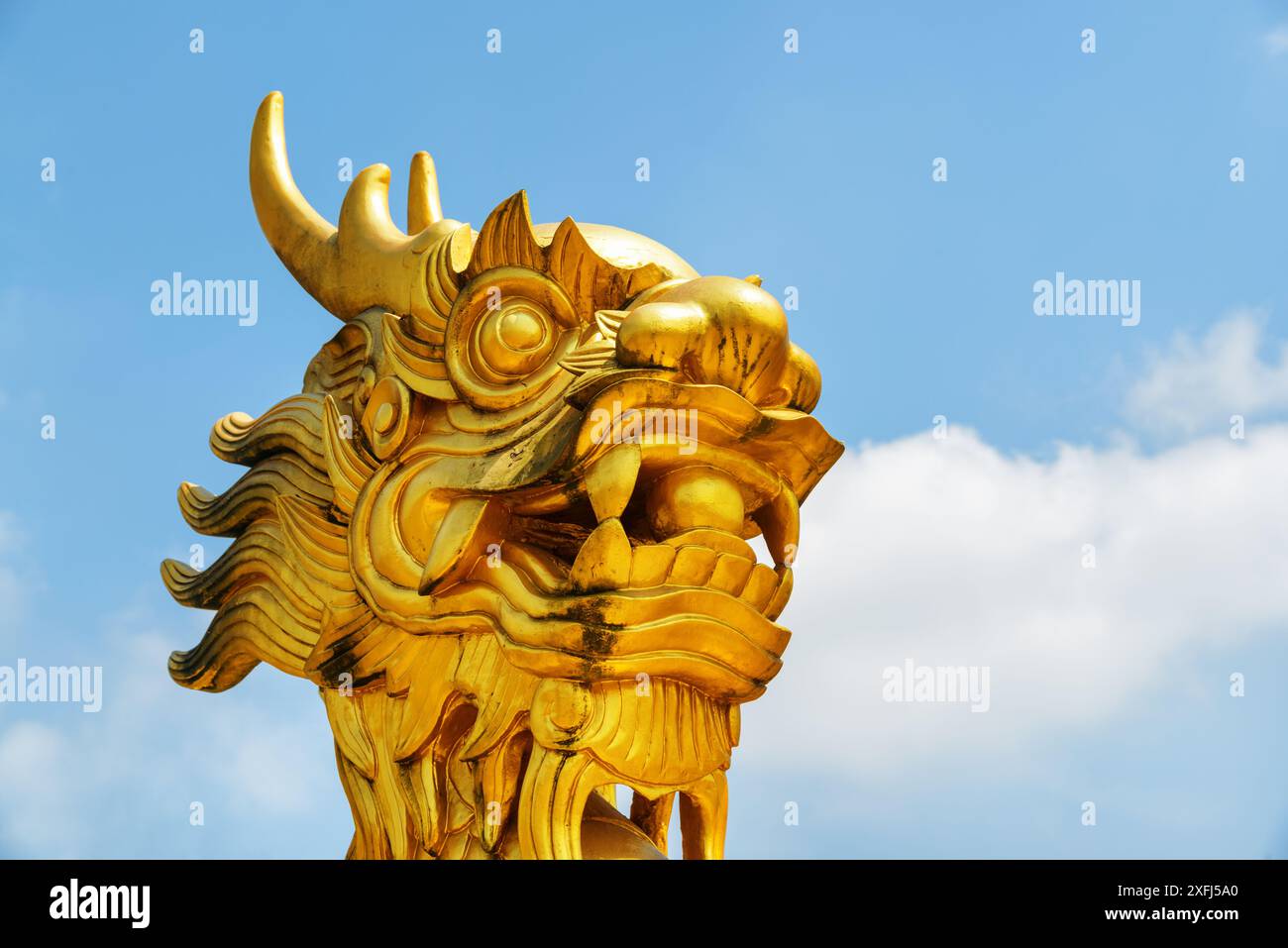 Amazing gilded sculpture of dragon on blue sky background at garden of ...