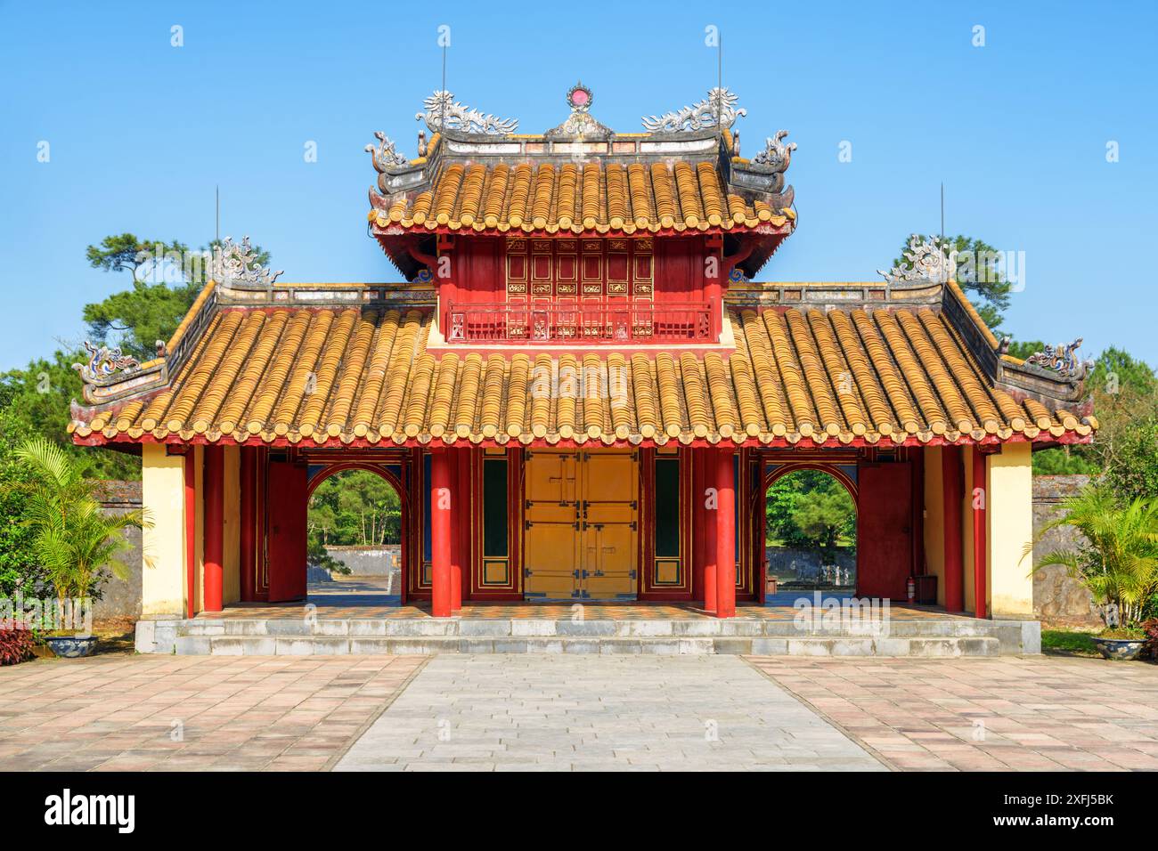 Scenic view of red-yellow Hien Duc Gate on blue sky background on ...
