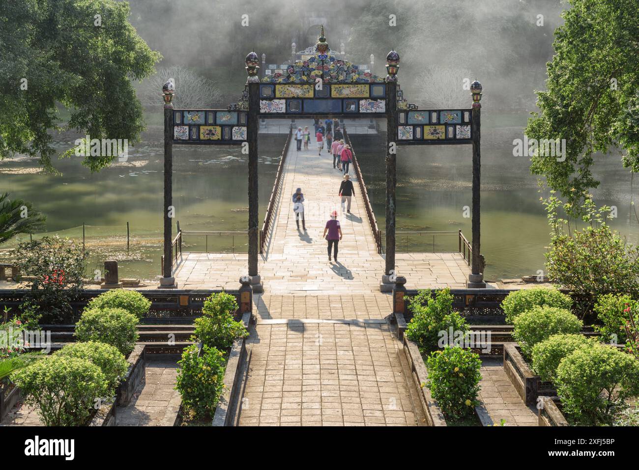 Tourists walking along bridge over the Lake of the New Moon (Tan Nguyet ...