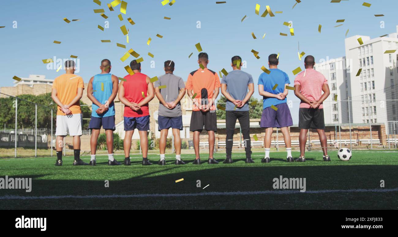 Image of confetti falling over back view of male football team on pitch ...