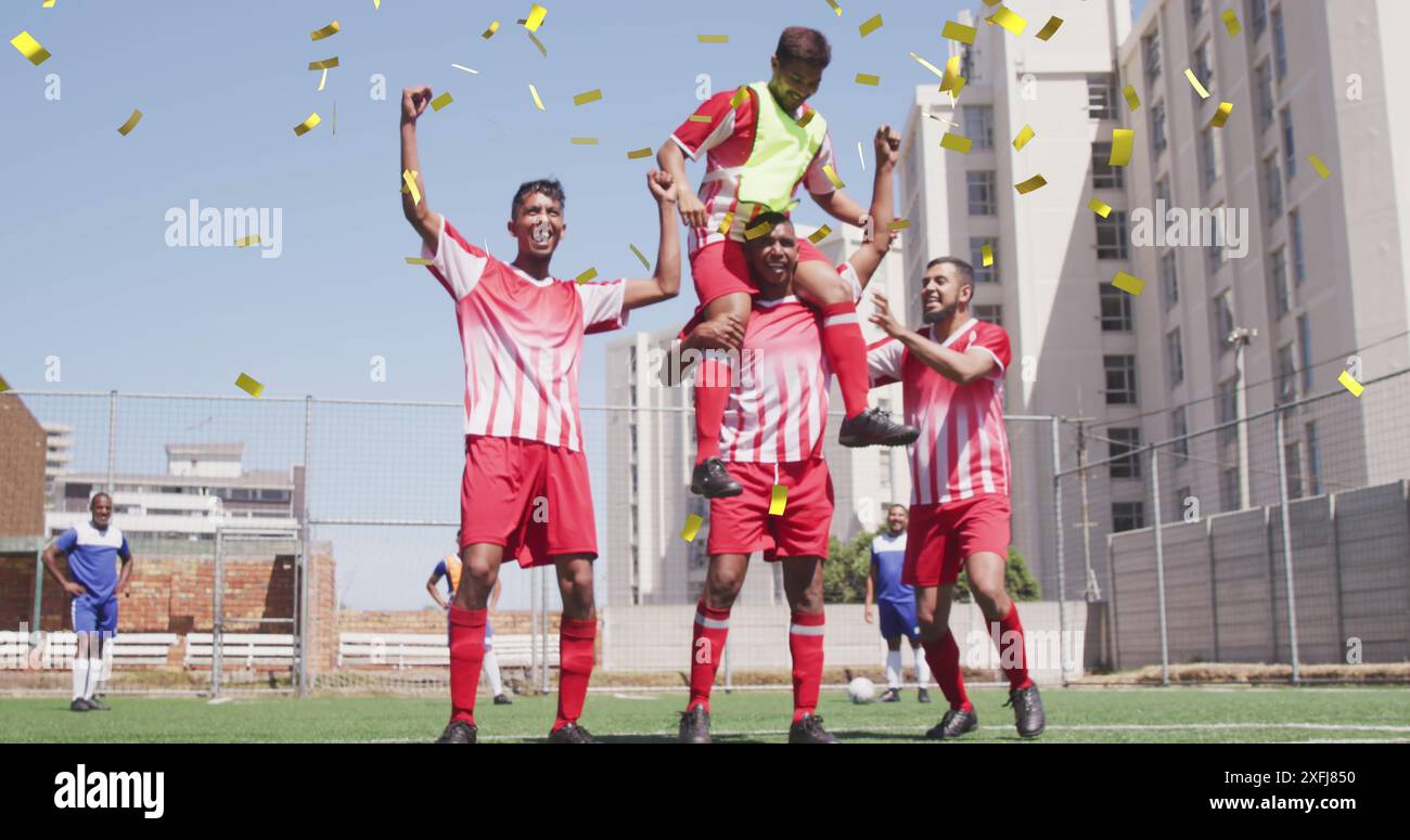 Image of confetti falling over male football team celebrating on pitch ...