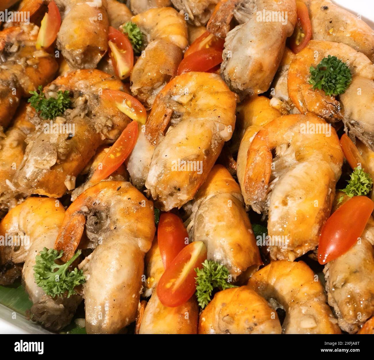 Closeup view of delectable prawn dish garnished with fresh herbs and ...