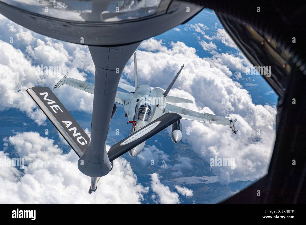 A NORAD CF-18 from the Canadian NORAD Region receives fuel from a 101st ...