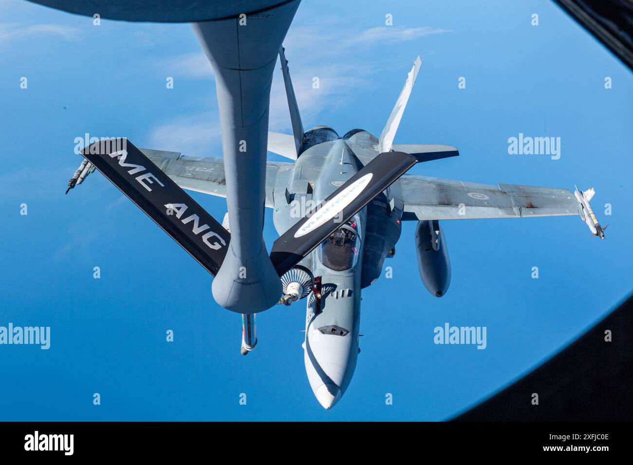 A NORAD CF-18 from the Canadian NORAD Region receives fuel from a 101st ...