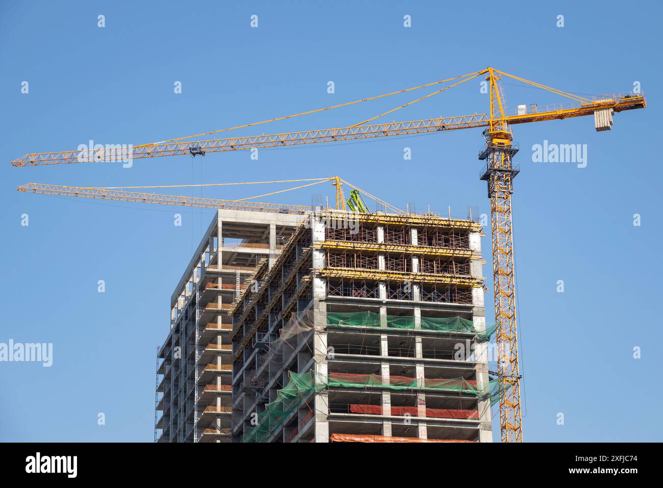 A crane on the construction of a high-rise building. Tashkent ...