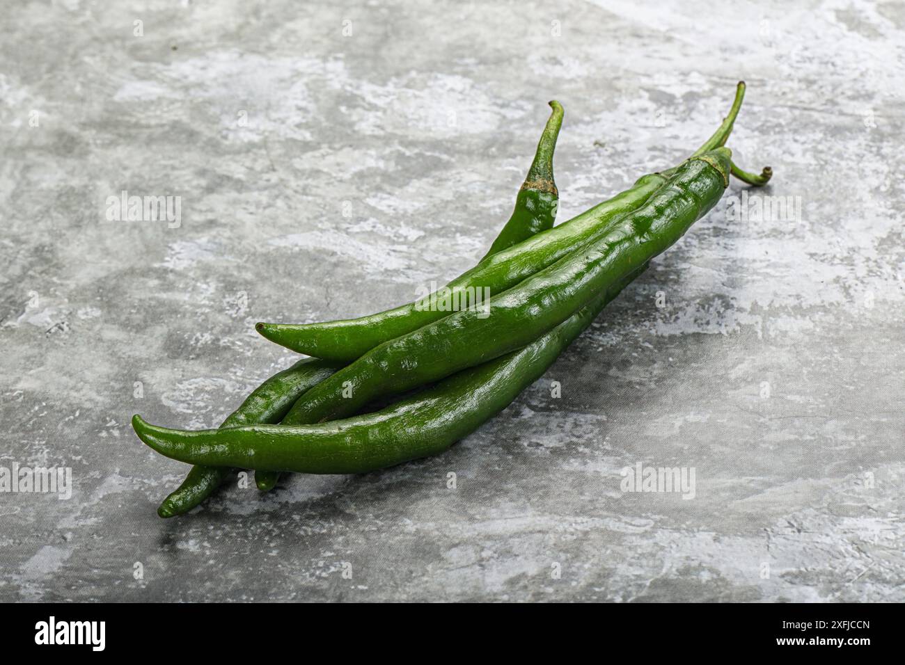Hot and spicy green chili pepper heap Stock Photo - Alamy