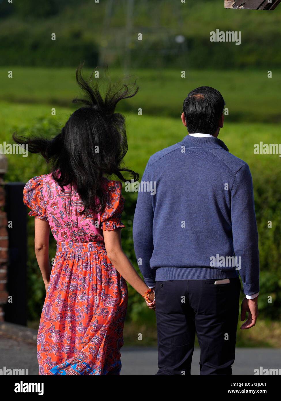 Prime Minister Rishi Sunak and his wife Akshata Murty leave after casting their vote in the 2024 ...