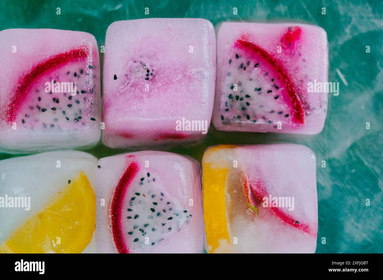 Square ice cubes with frozen fruit inside Pitaya pitahaya fruit, lime ...