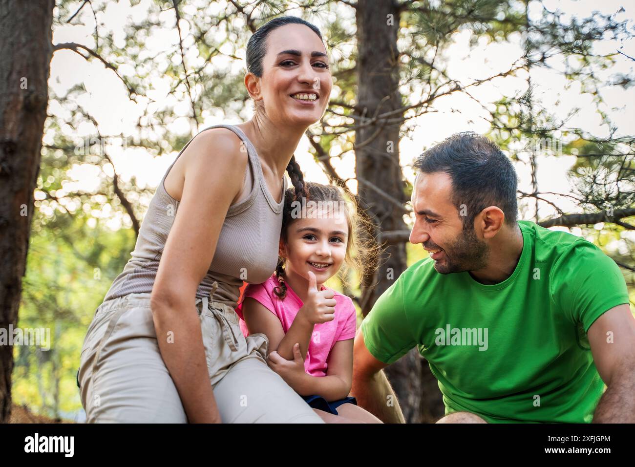 Happy family bonding in nature - portrait of smiling parents and child ...