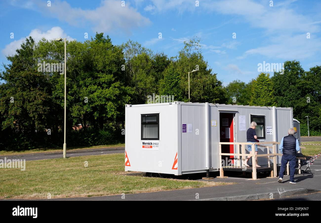 Retransmitting amending caption to temporary building A person leaves a ...