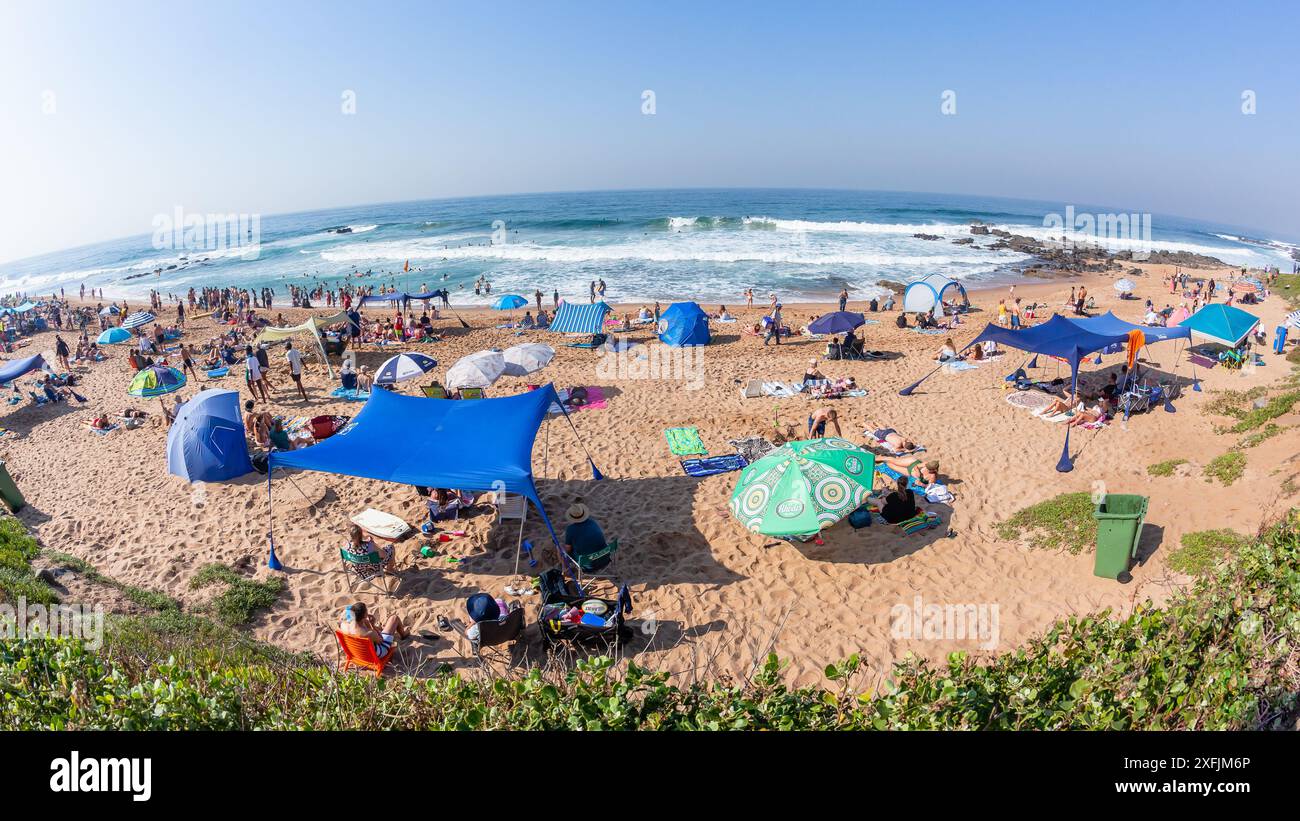 Beach blue sea ocean waves holiday crowd people sunbathing on sand a ...
