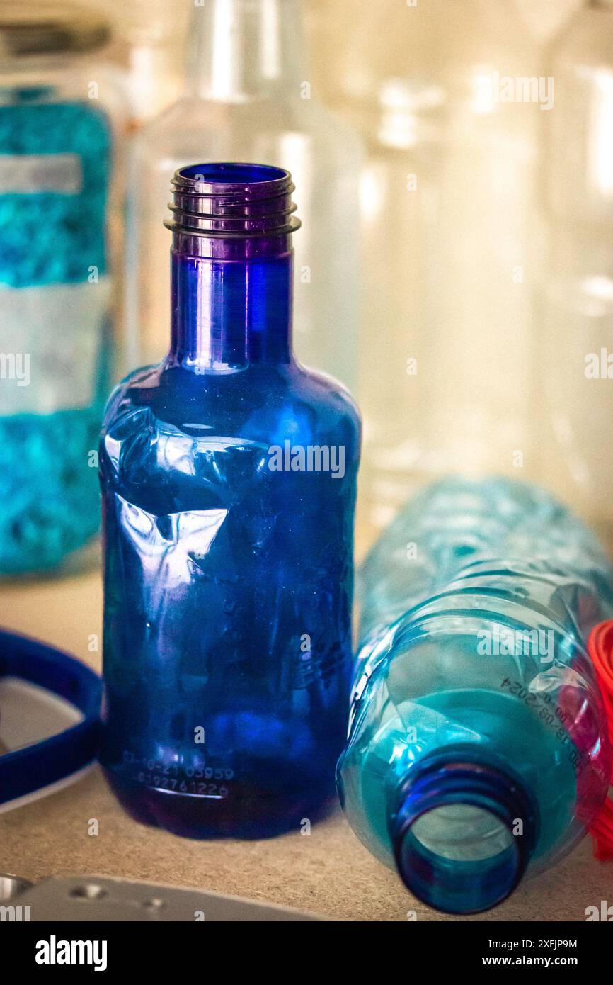 Collection of blue plastic water bottles on blurred background ...