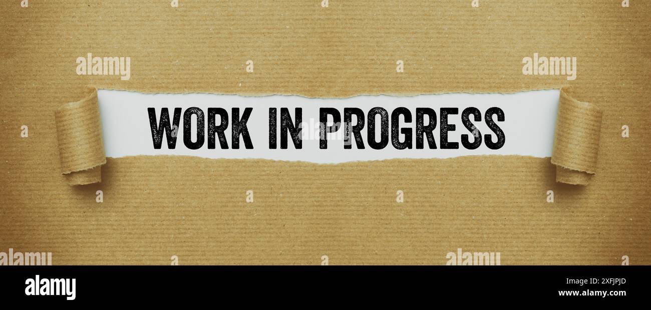 Torn paper revealing the words Work in progress Stock Photo - Alamy