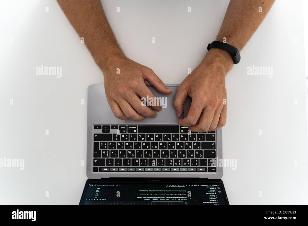 Image of a man's hands with a watch typing on a laptop keyboard Stock ...