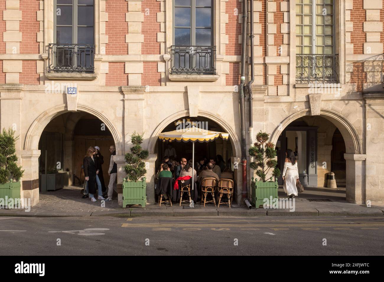 Diners enjoy the setting sun under the arches of the Cafe Hugo off the ...