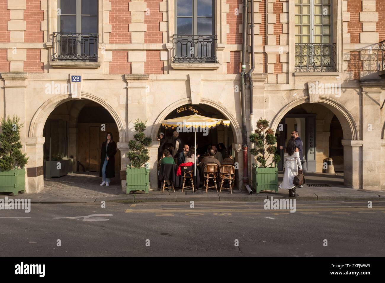 Diners enjoy the setting sun under the arches of the Cafe Hugo off the ...