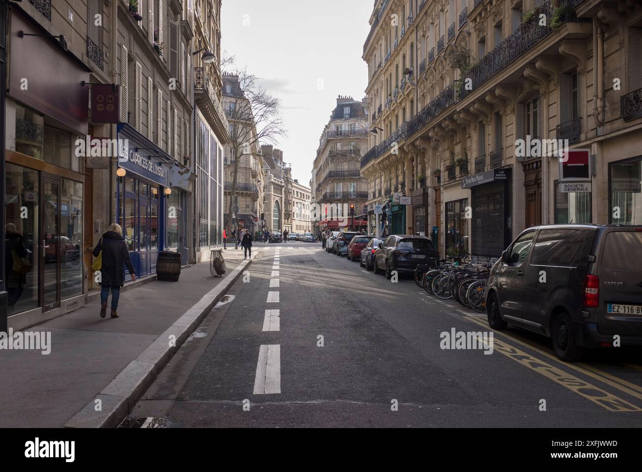 Pedestrians walk down a side street in Paris, France Stock Photo - Alamy