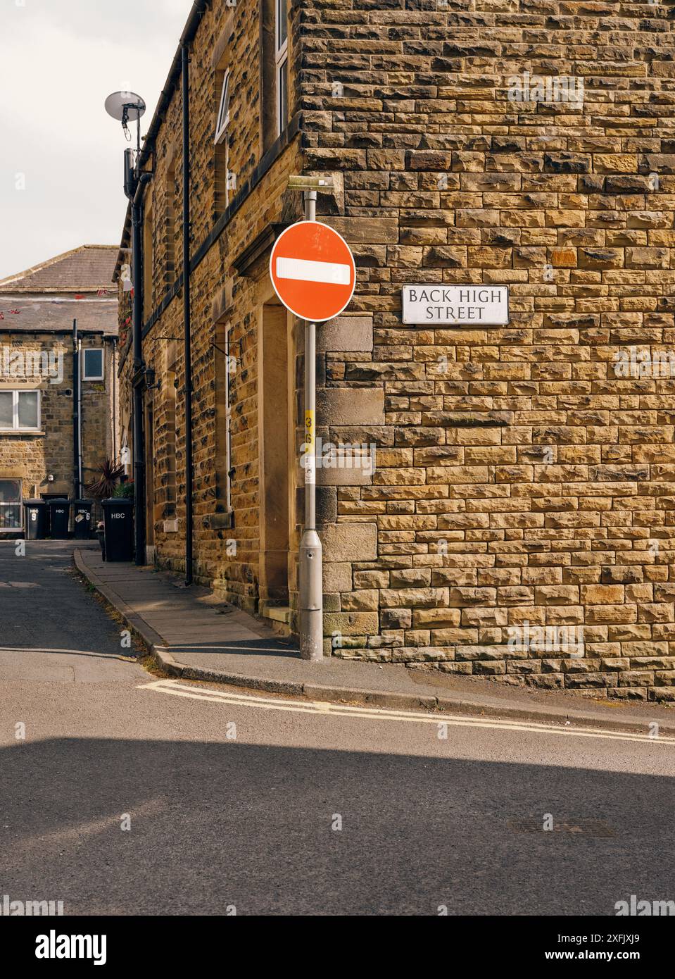 An empty Yorkshire street with brickwork and a no entry road sign ...