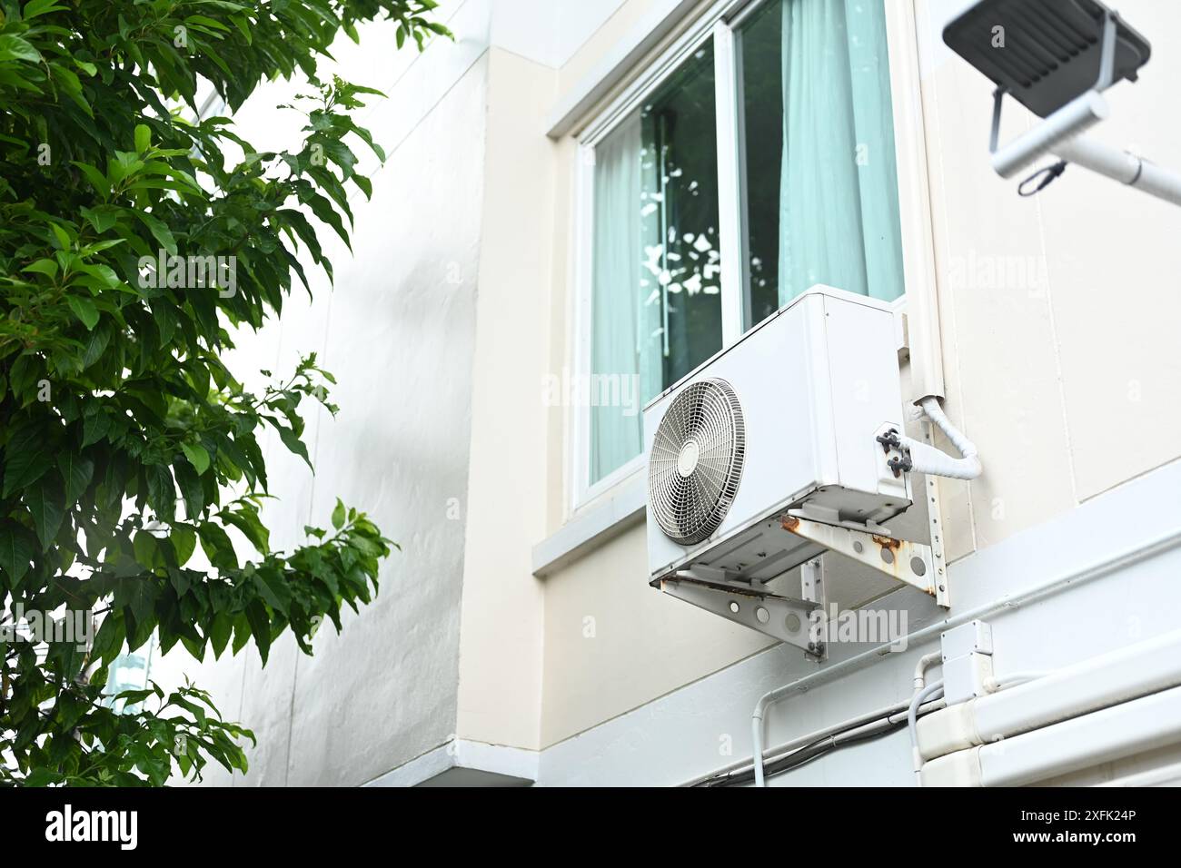 Air conditioner compressor installed outside the house Stock Photo - Alamy