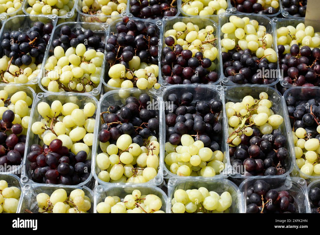 Dark and green grapes in bowls on a market stall, top view, Germany ...