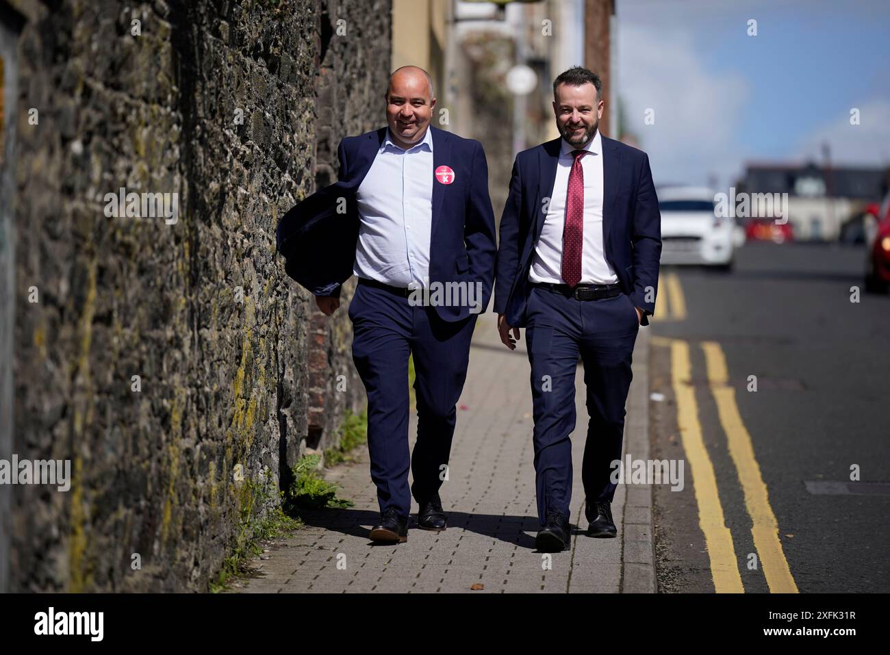 SDLP leader Colum Eastwood (right) arrives with Councilor Brian Tierney ...