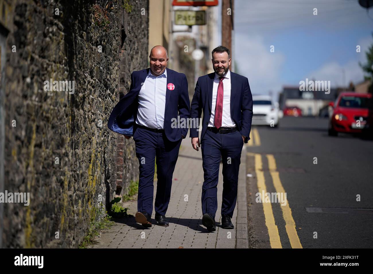 SDLP leader Colum Eastwood (right) arrives with Councilor Brian Tierney ...