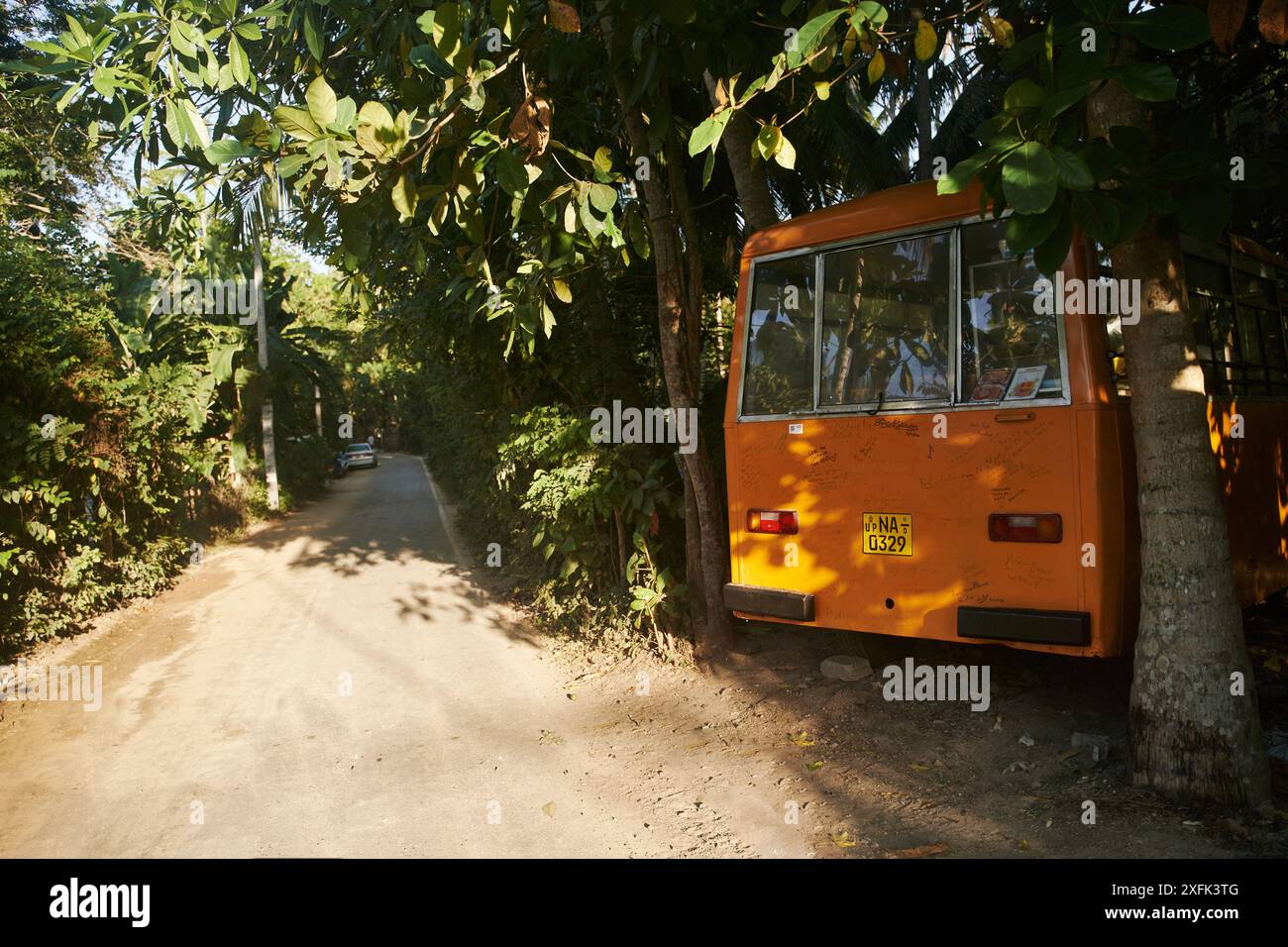 Dikwella, Sri Lanka - 22.02.2022: Old orange bus standing under trees ...