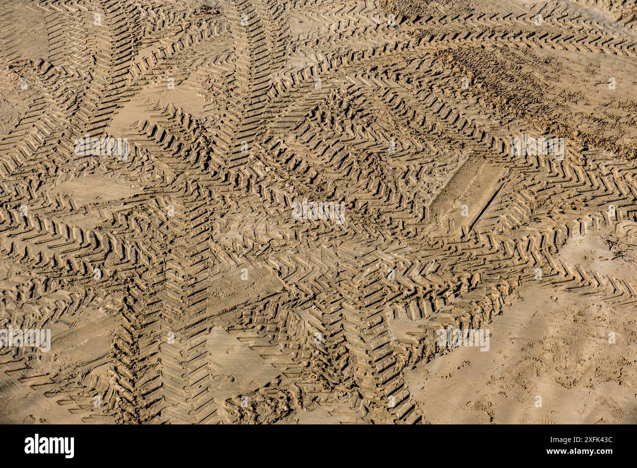 Tyre tire marks in the sand on a beach in Newquay in Cornwall in the UK ...