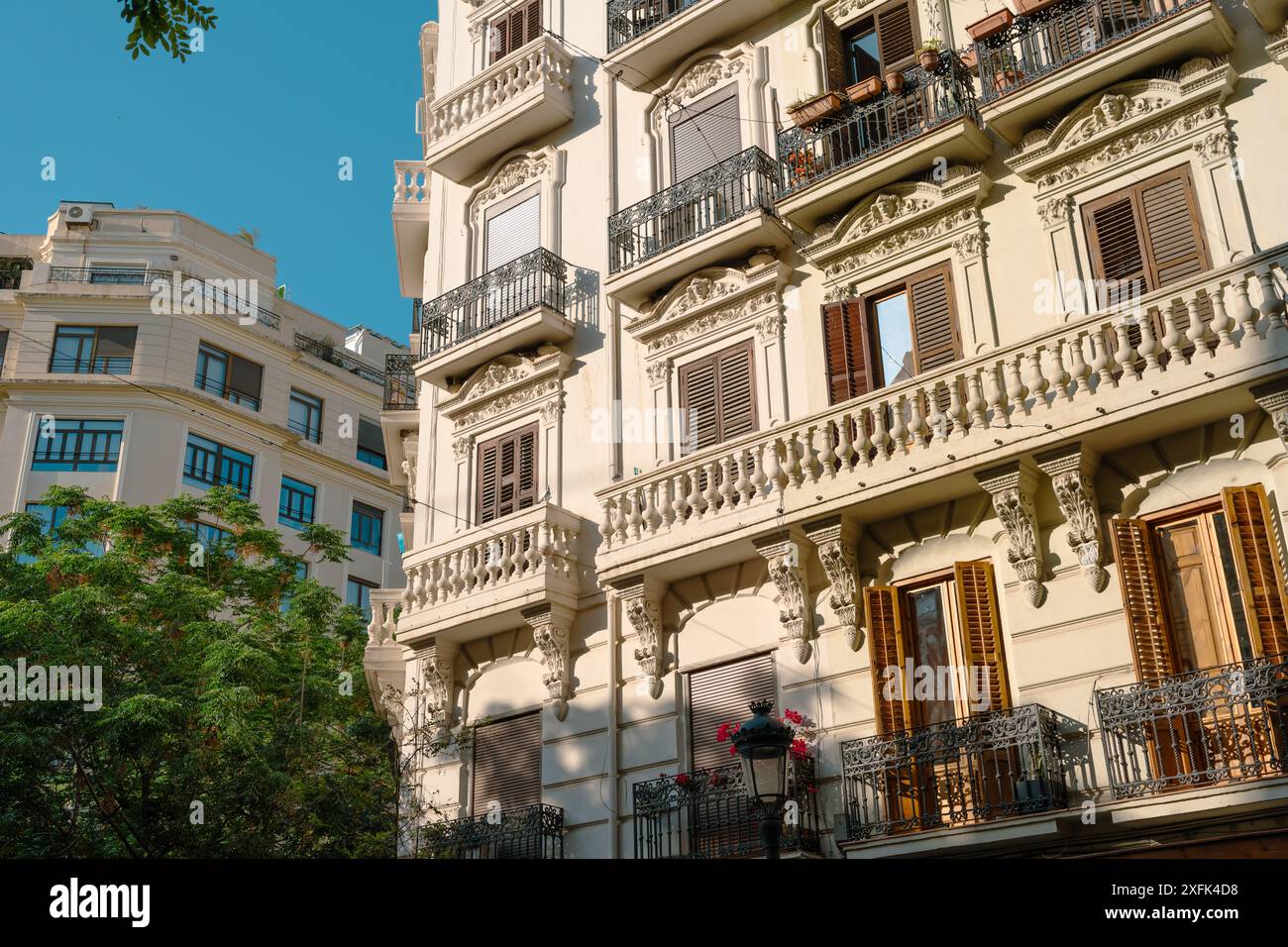 Two historic buildings with ornate balconies and intricate facades. The ...