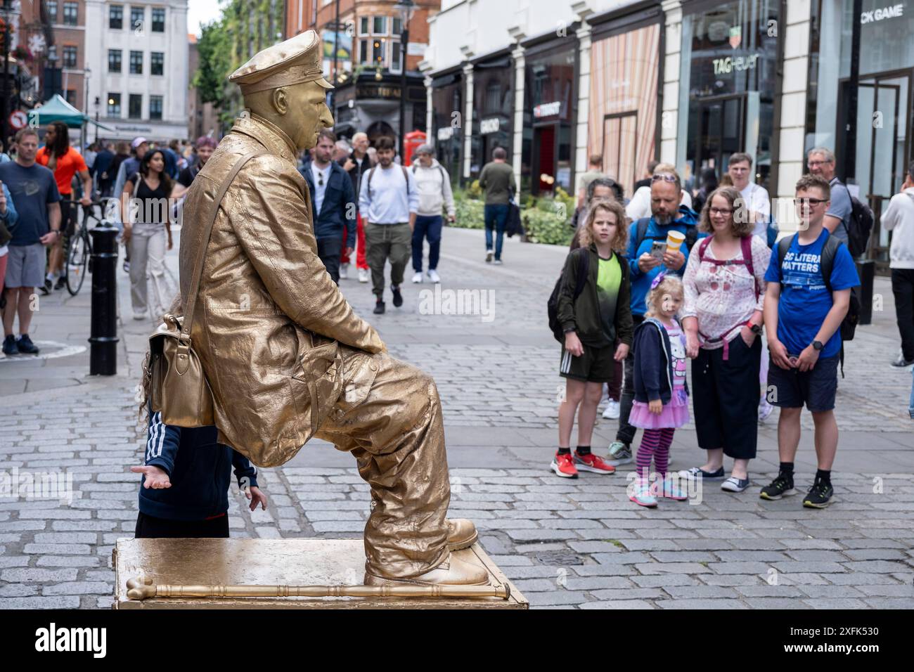 Street performer as a metallic painted balancing Living Statue in ...