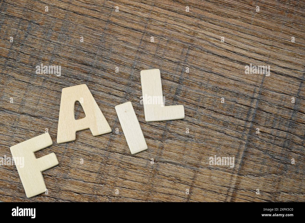 Jumbled letters spelling out FAIL on a woodgrained background Stock ...