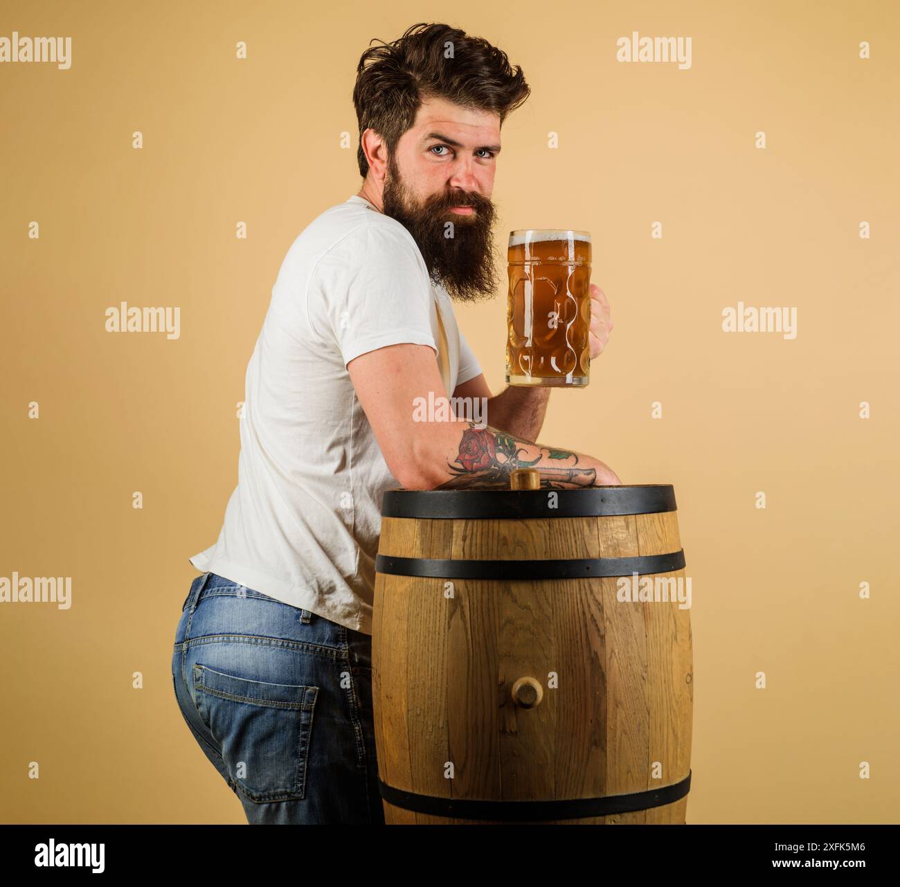 Beer pub. Stylish handsome man tasting craft beer at restaurant or bar ...