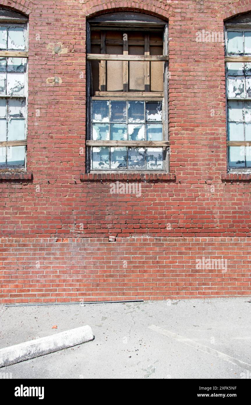 Abandoned brick industrial building with broken and weather worn ...