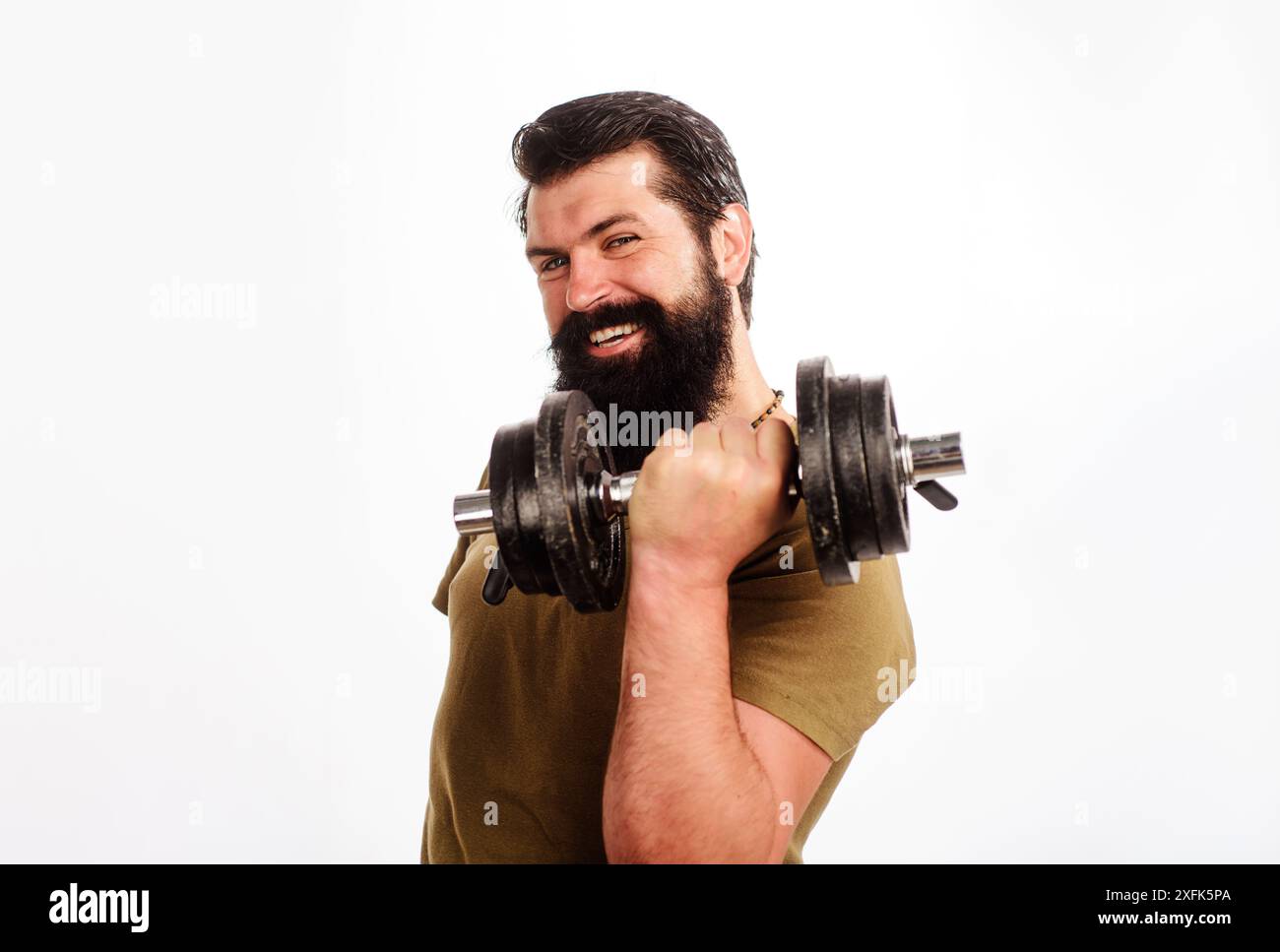 Smiling bearded sportsman lifting dumbbell at gym. Healthy sports lifestyle and fitness ...