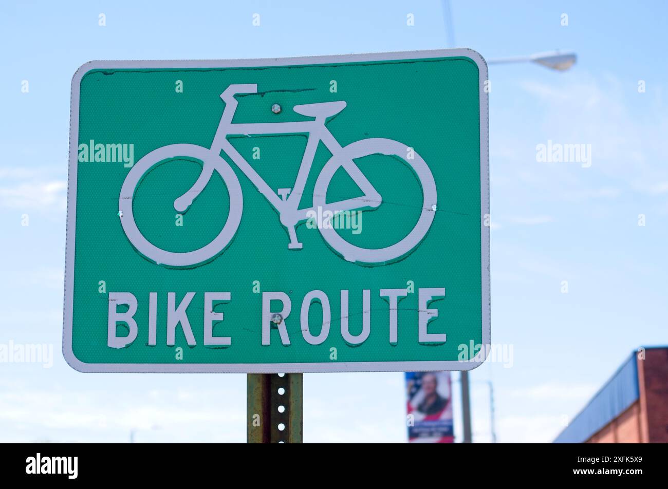 Bike route sign that is faded and peeling Stock Photo - Alamy