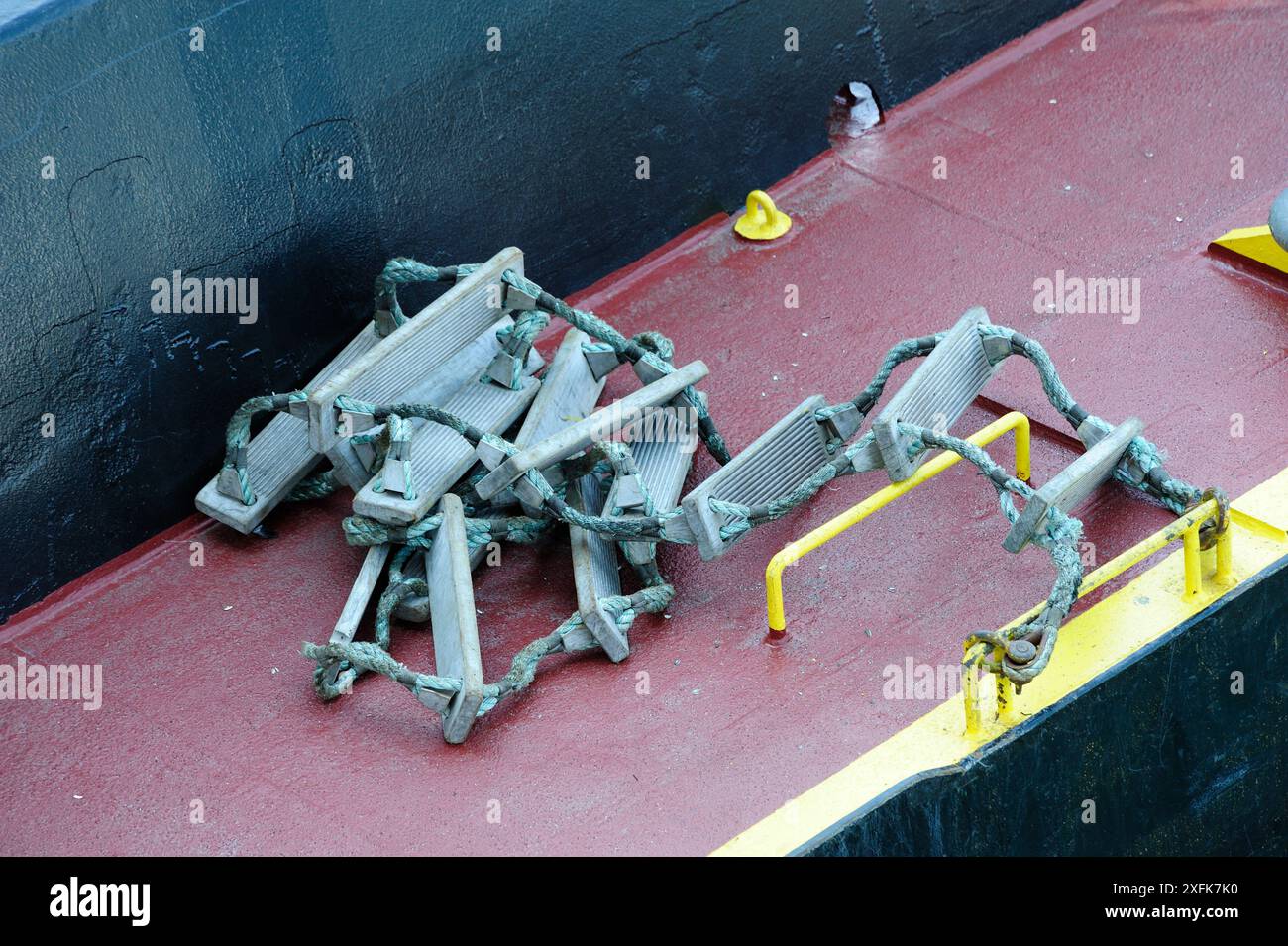 Coil of ships rope ladder on a deck Stock Photo - Alamy