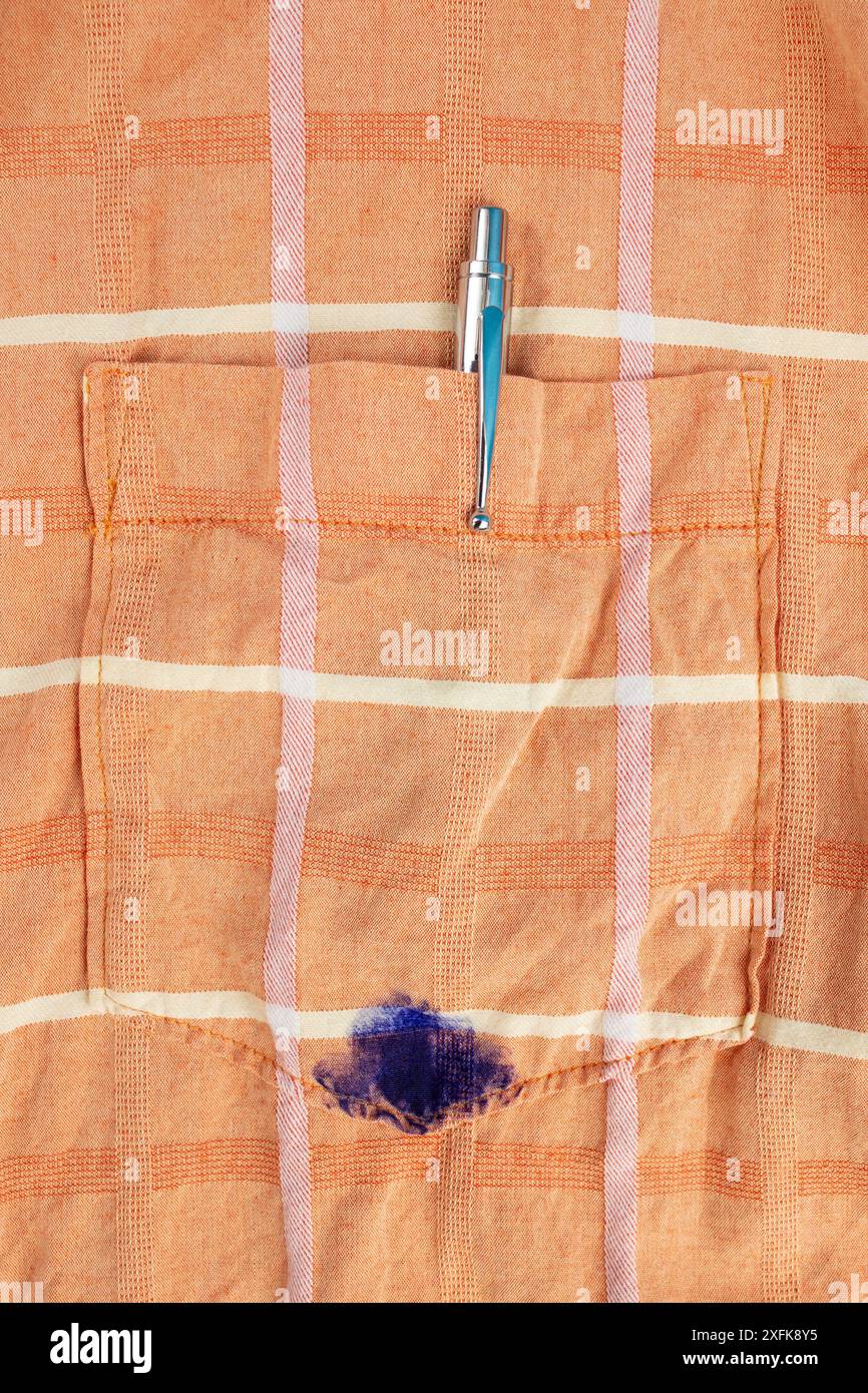 Blue ink spill in a orange checkered wrinkled shirt front pocket Stock ...