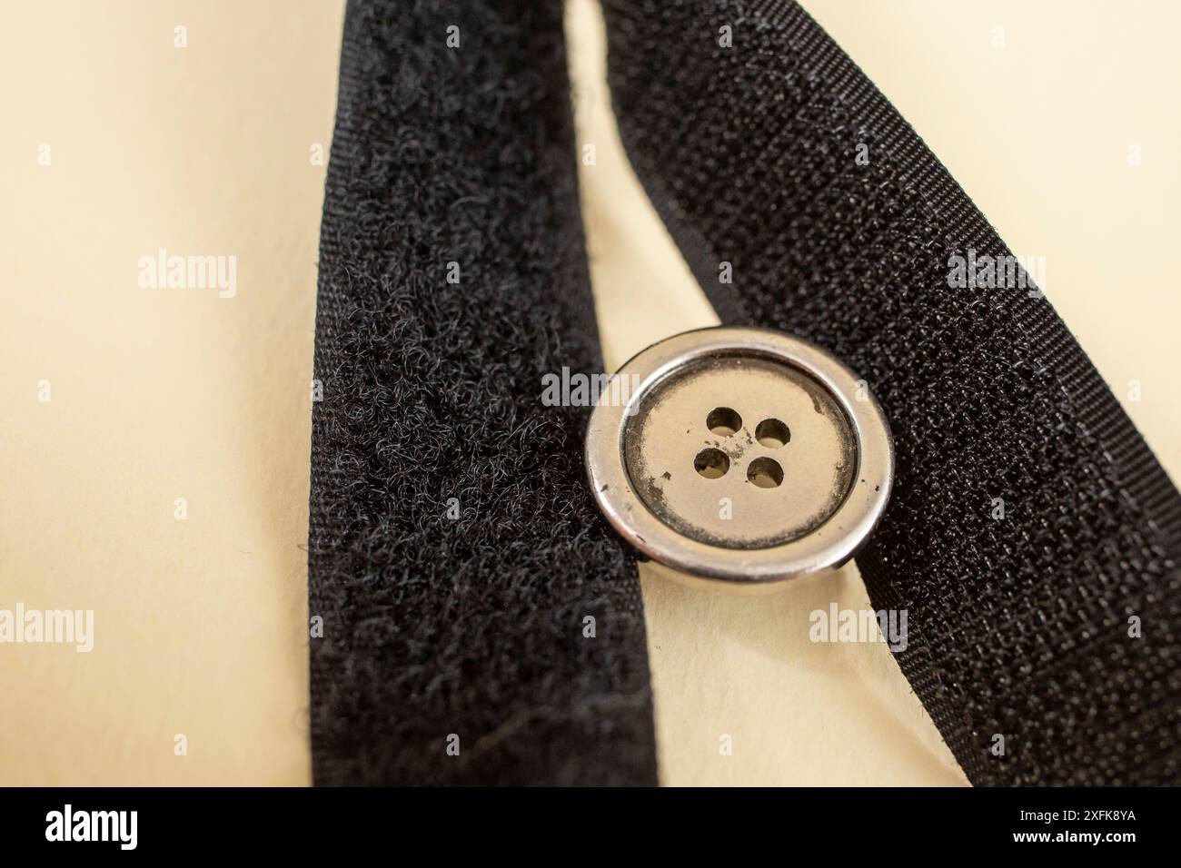 Fastener Velcro tape and a button on beige background, soft focus Stock ...