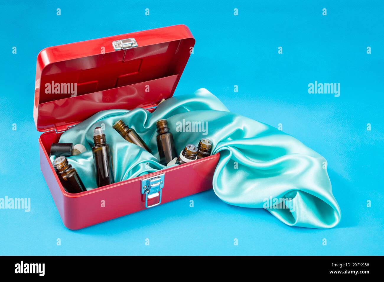 First aid kit metallic red case with essential oil bottles and ...