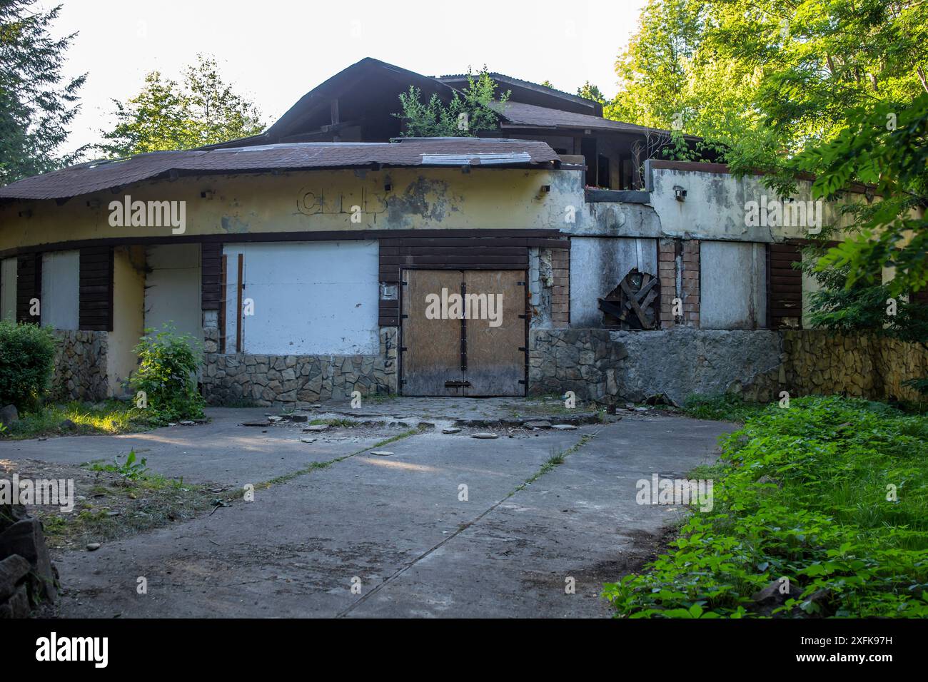 Abandoned building in ruins in a park or forest, obsolete structure ...